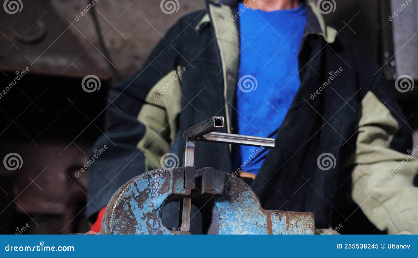 Working with Metal in the Workshop. a Man Wearing a Welding Mask To ...