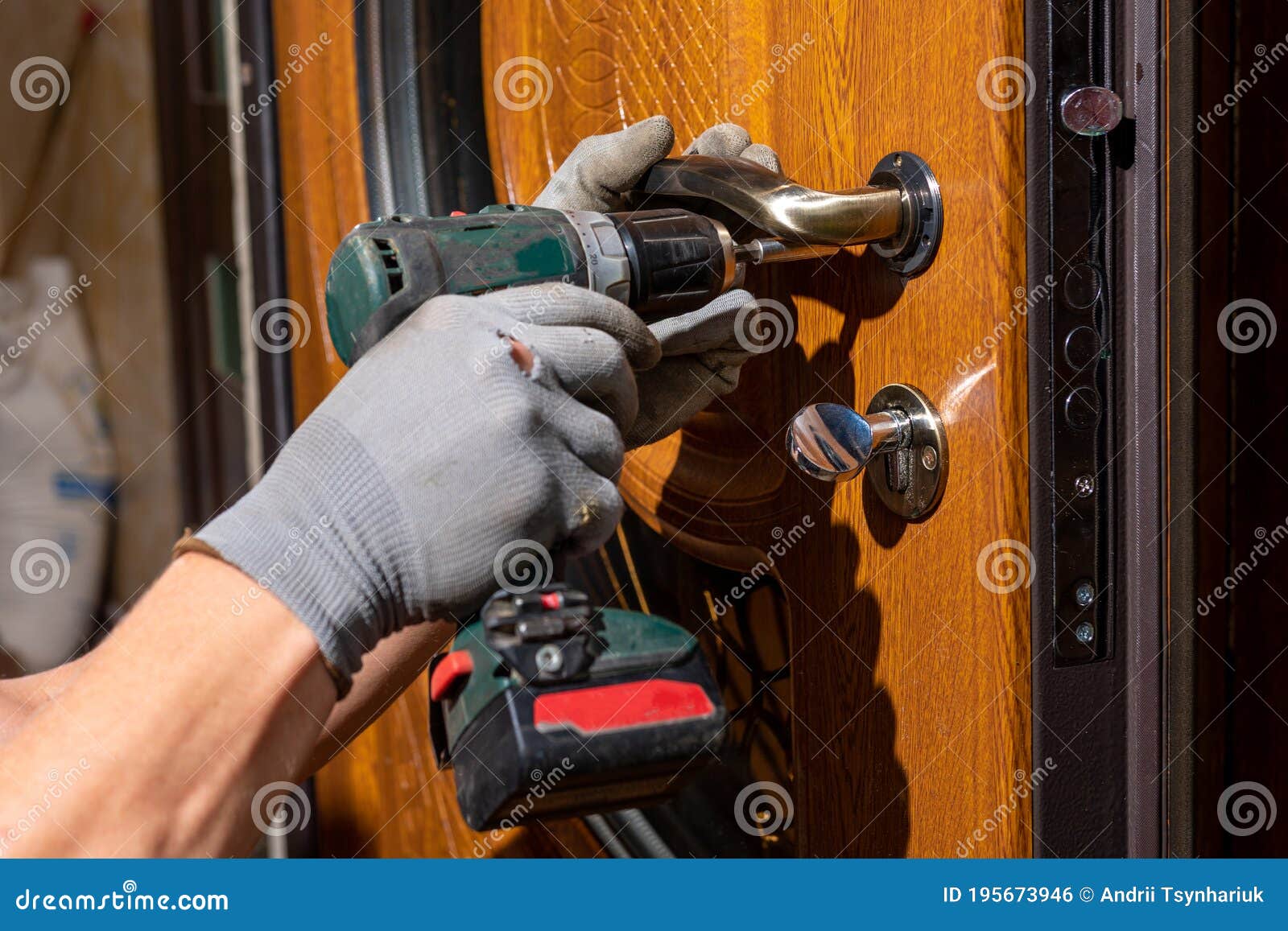The Master Worker Installs a Door Lock in the Front Door, Metal Doors ...