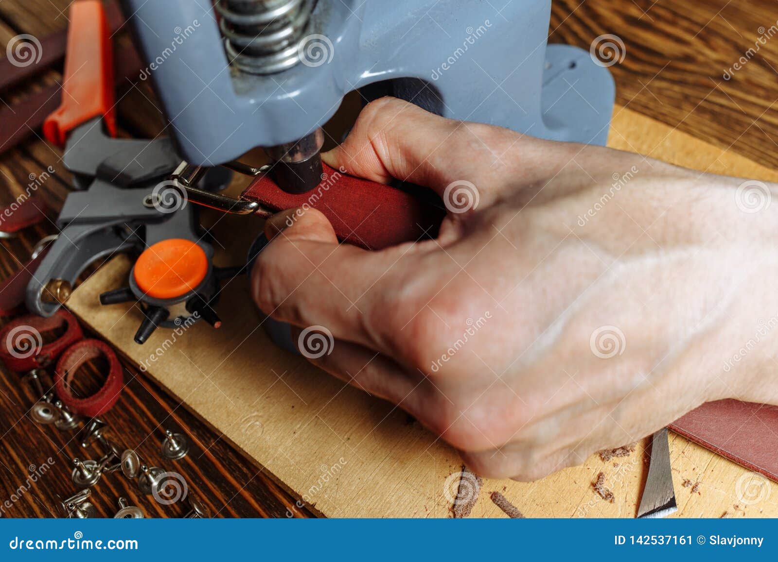 Master is Working on Press with Skin. on Brown Wooden Table Scattered ...