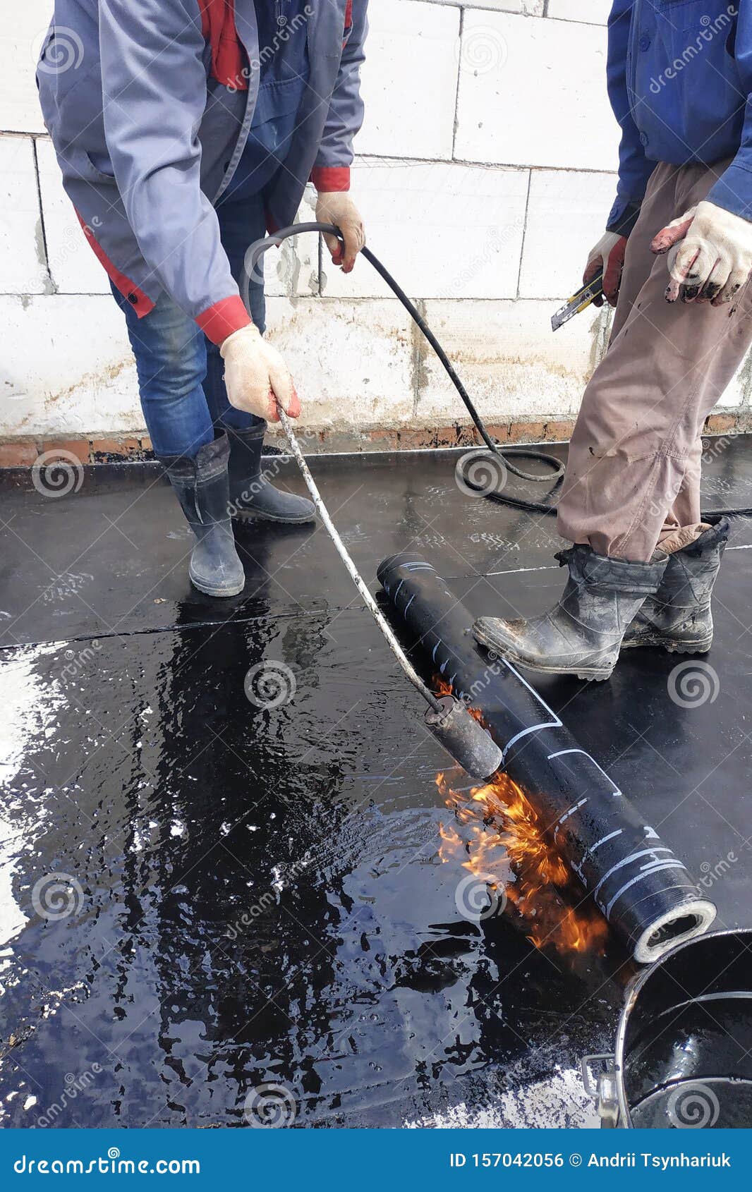 The Master Works with the Assistant To Work on the Waterproofing of the ...