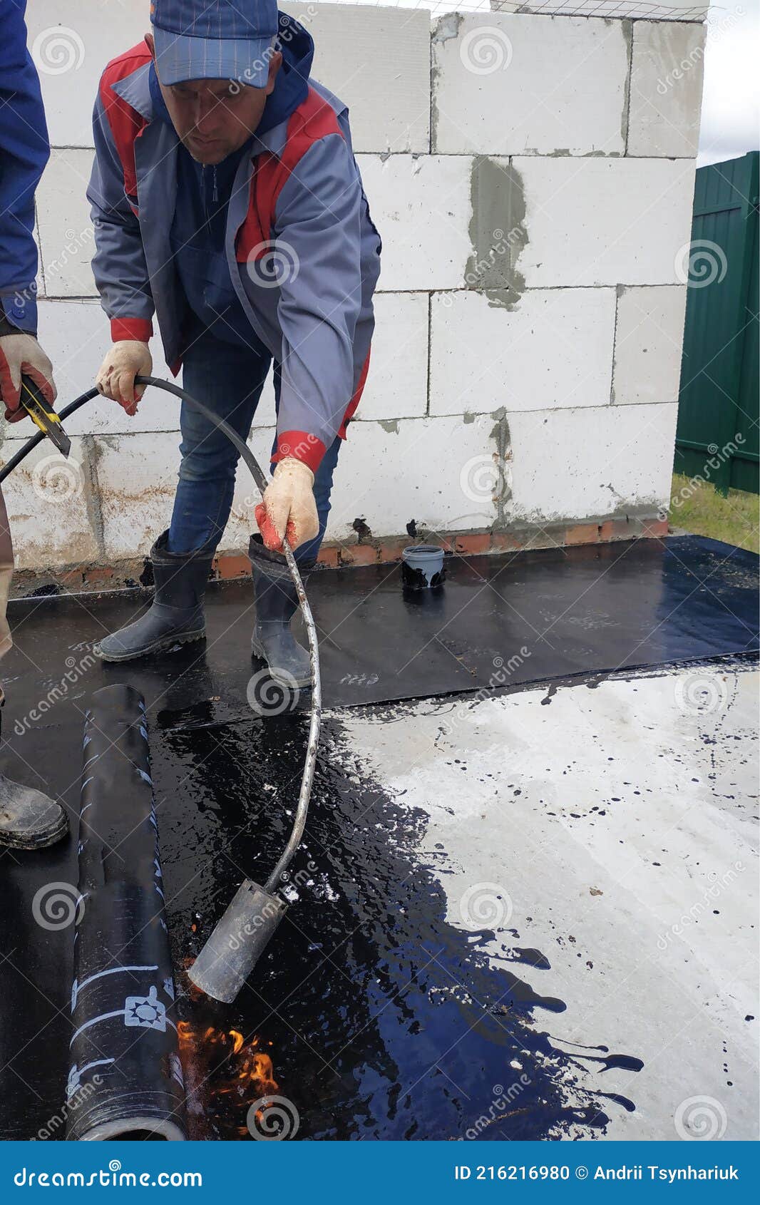 The Master Works with the Assistant To Work on the Waterproofing of the ...