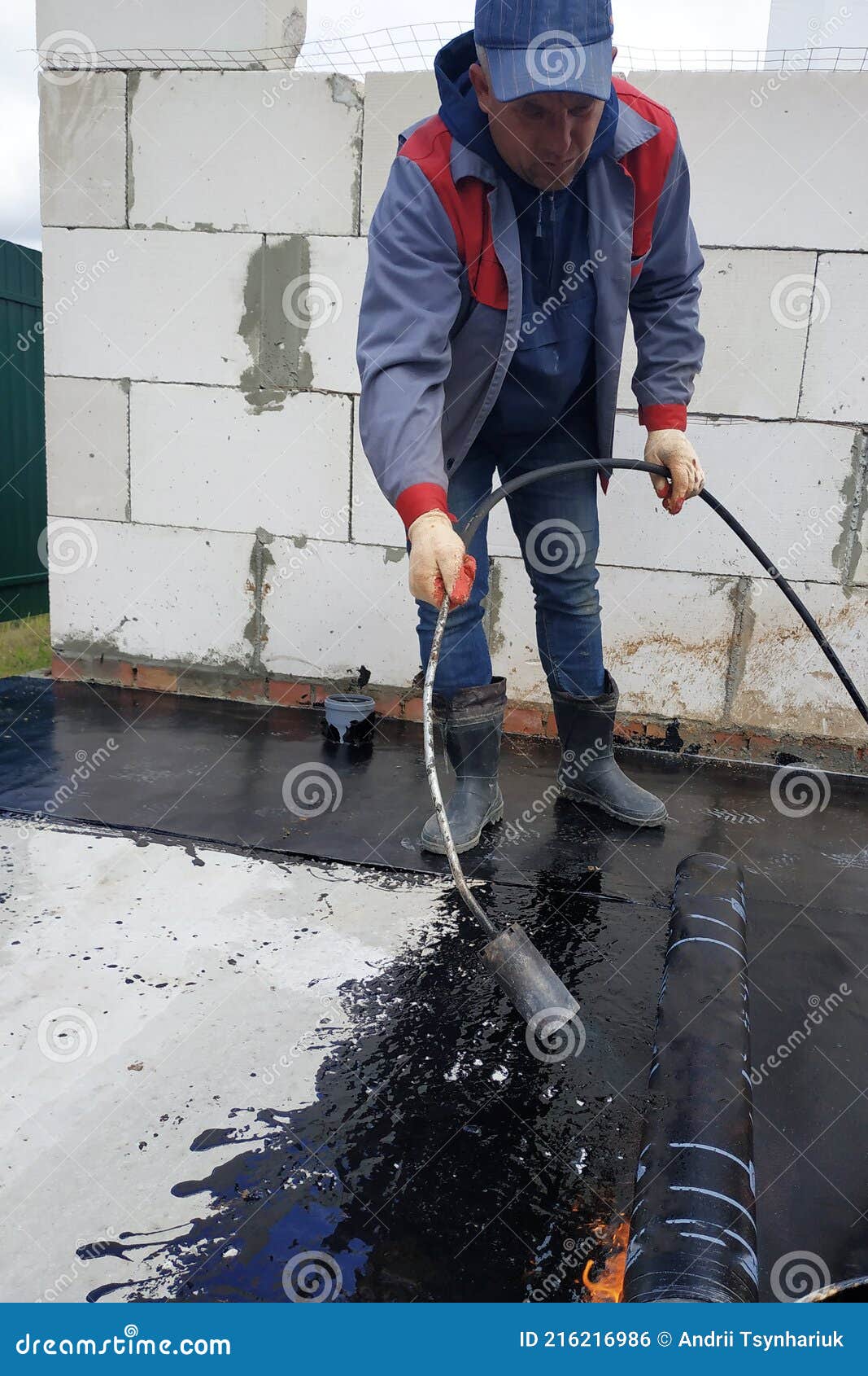 The Master Works with the Assistant To Work on the Waterproofing of the ...