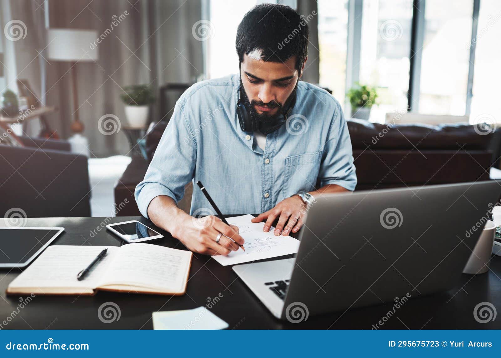 He Mastered Working from Home Effectively. a Young Man Making Notes ...
