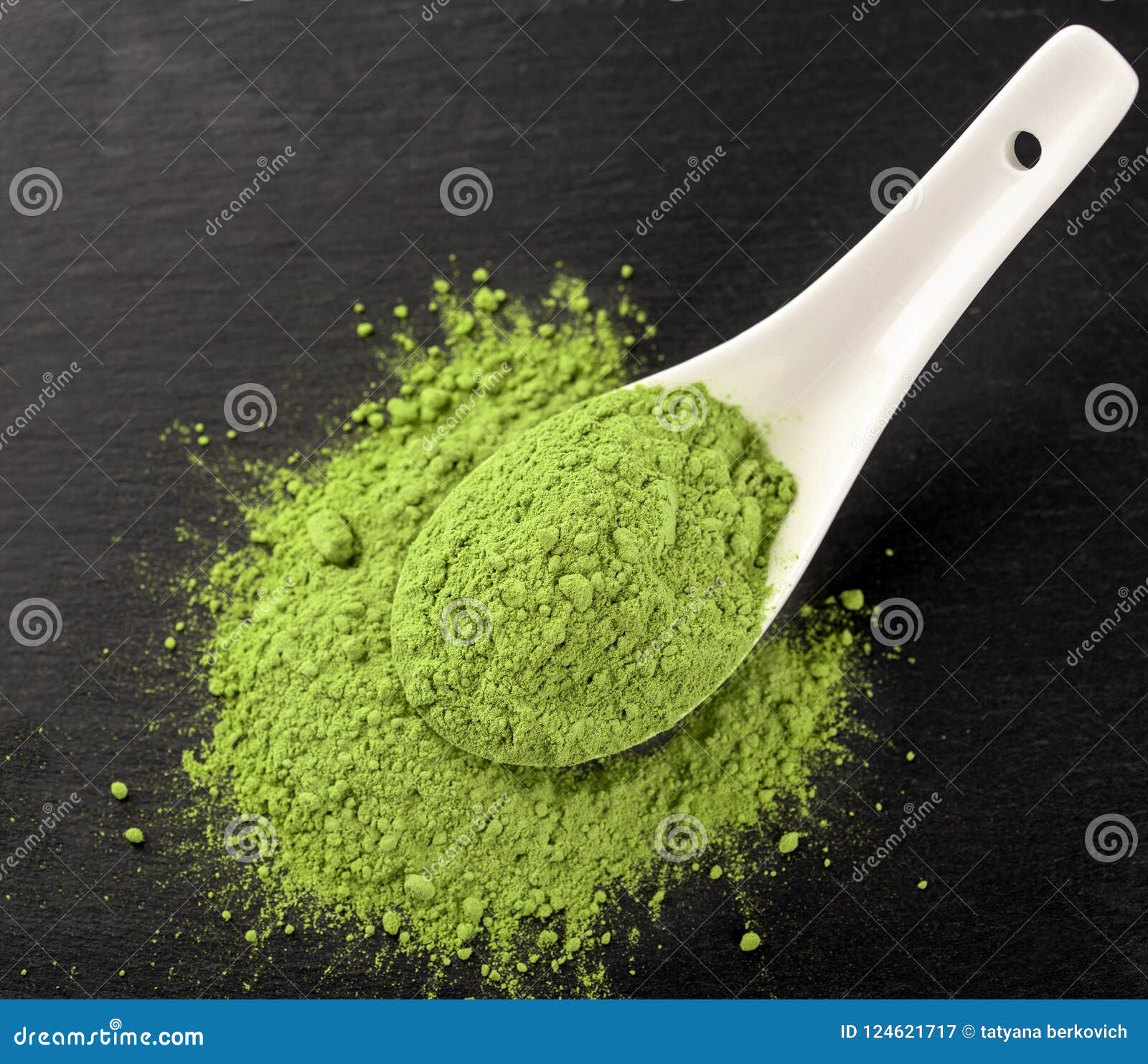 Matcha Powder in White Ceramic Spoon and Tea Leaves on Black Background ...