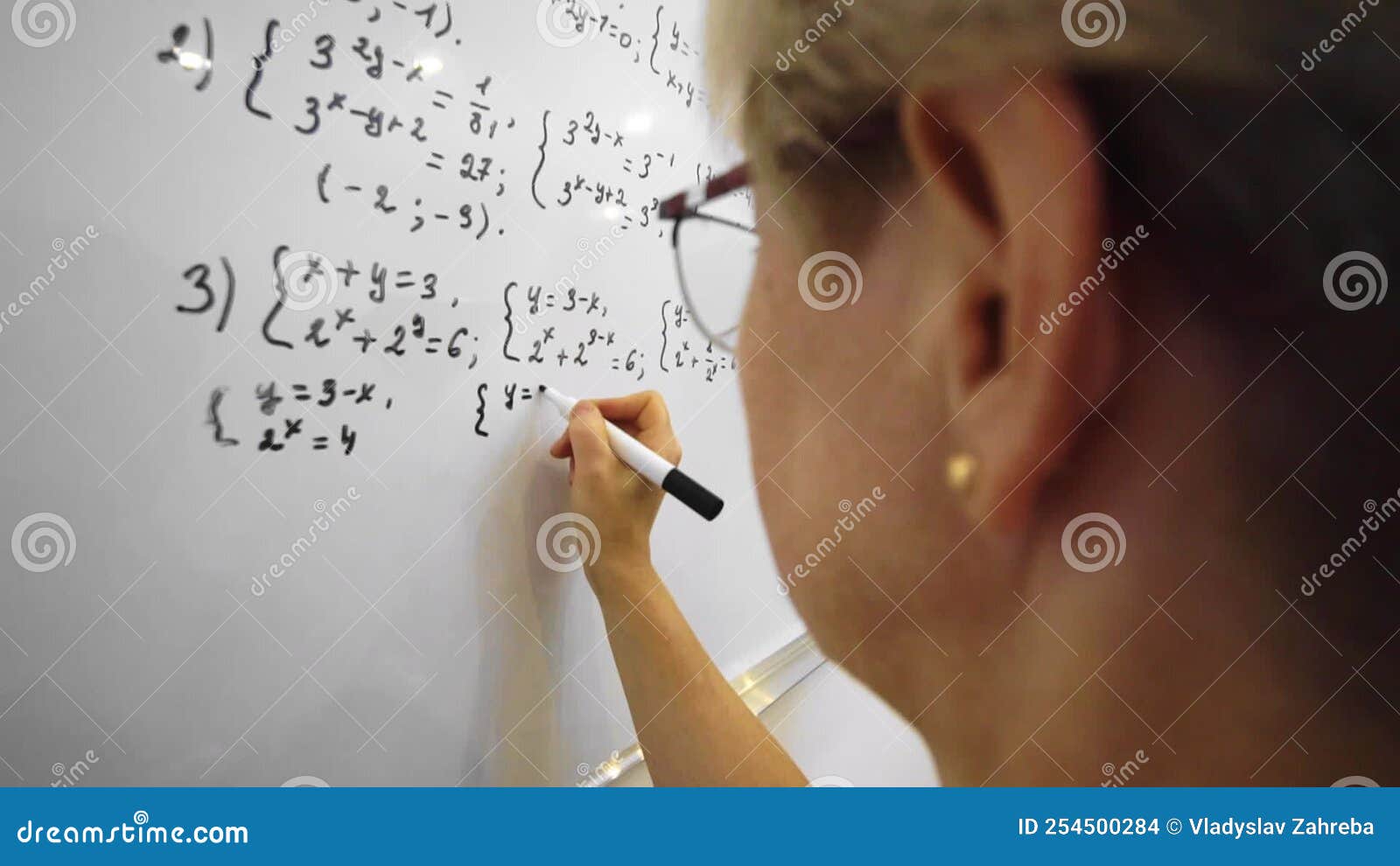 Aged Teacher is Solving Math Equation on Whiteboard Close Up. Stock ...
