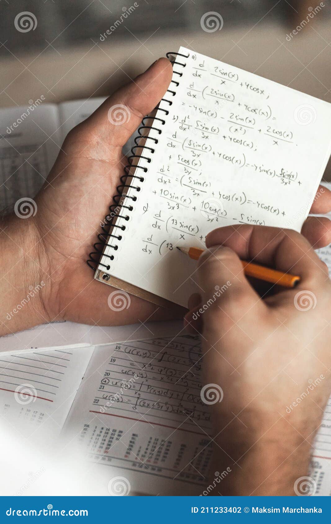 Math Formulas are Written in Pencil in a Notebook Holding Man in Stock ...
