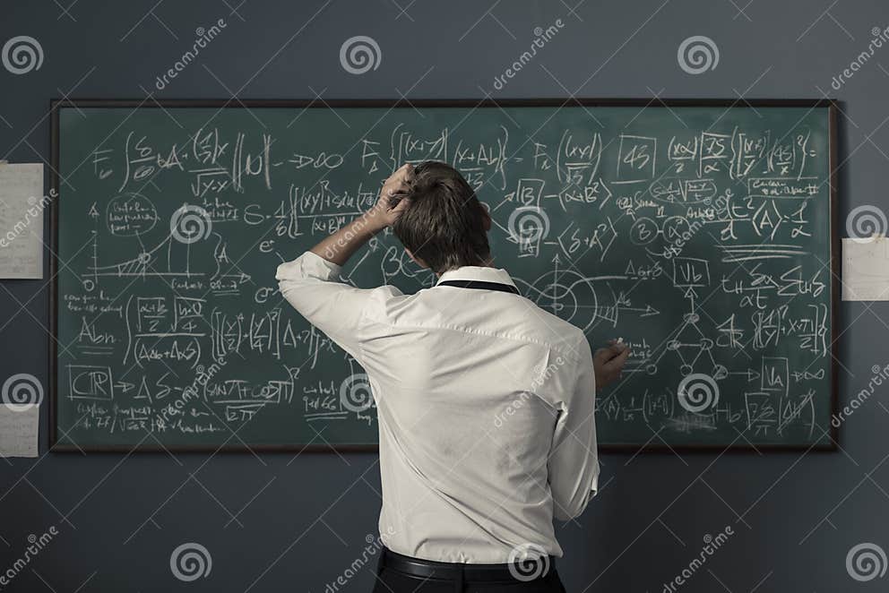 Mathematician Solving Problems and Writing Formulas on the Chalkboard ...