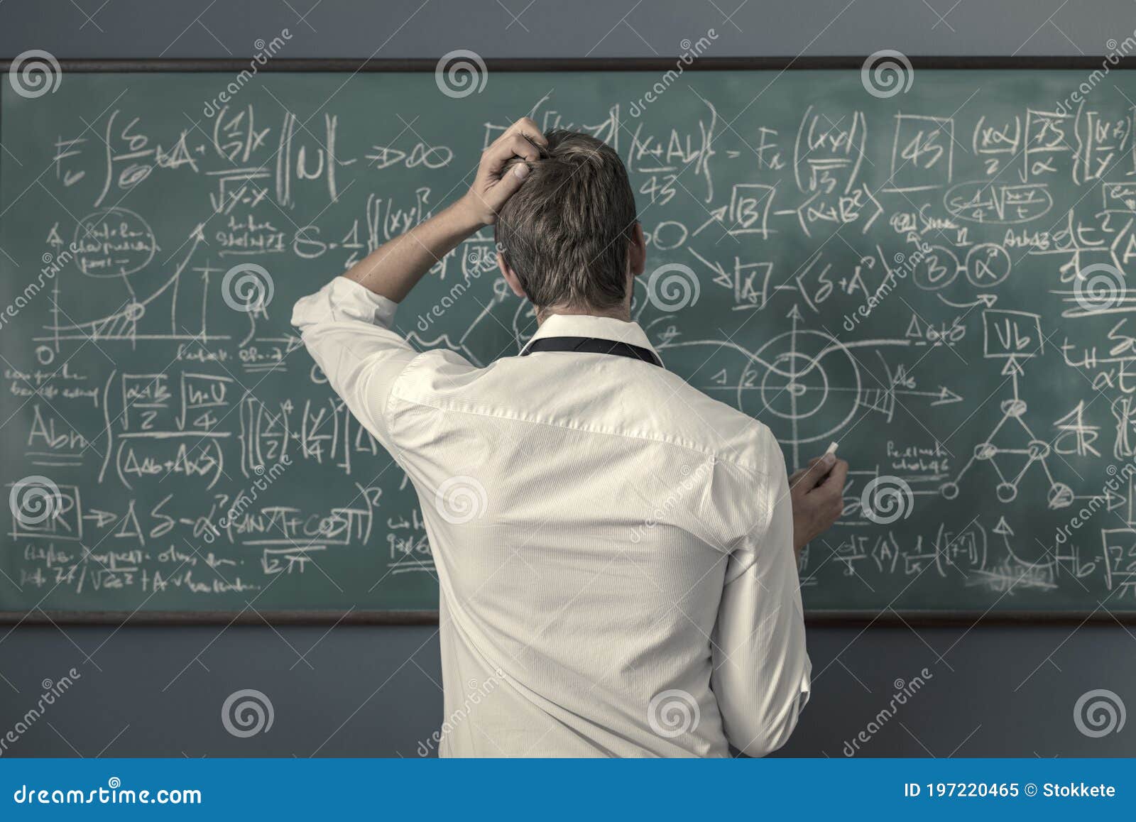 Mathematician Solving Problems and Writing Formulas on the Chalkboard ... Mathematician Solving Problems and Writing Formulas on the Chalkboard ...