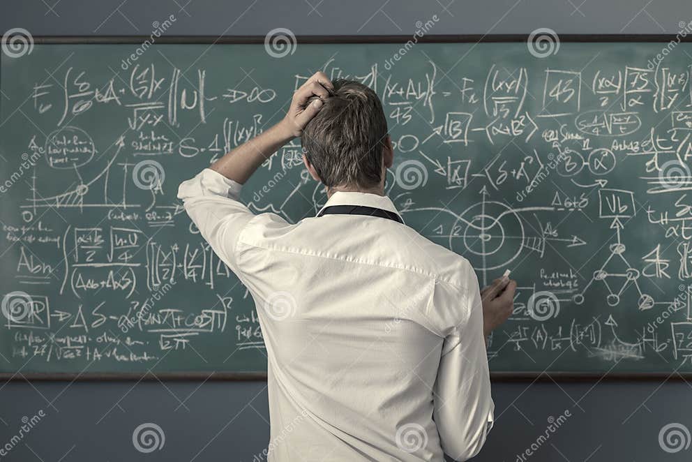 Mathematician Solving Problems and Writing Formulas on the Chalkboard ...