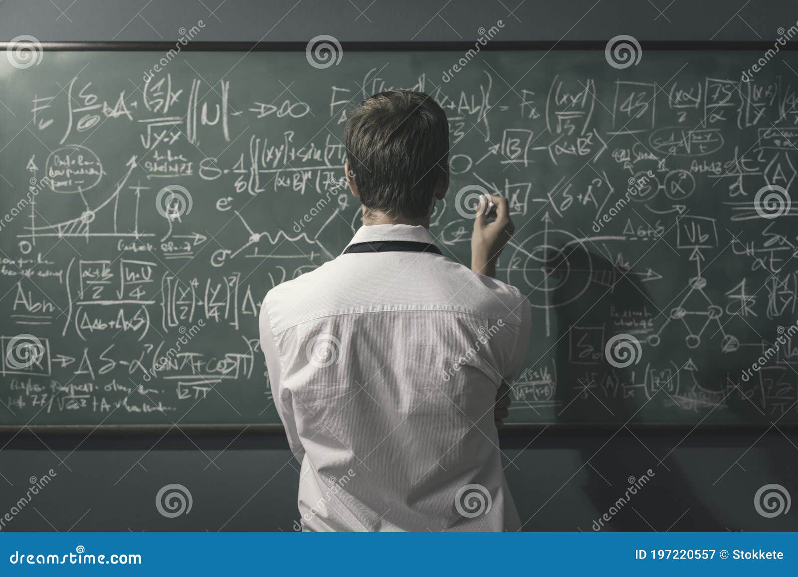 Mathematician Solving Problems and Writing Formulas on the Chalkboard ...