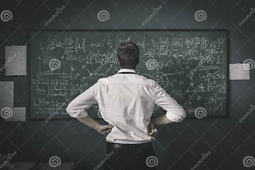 Mathematician Solving Problems and Writing Formulas on the Chalkboard ...