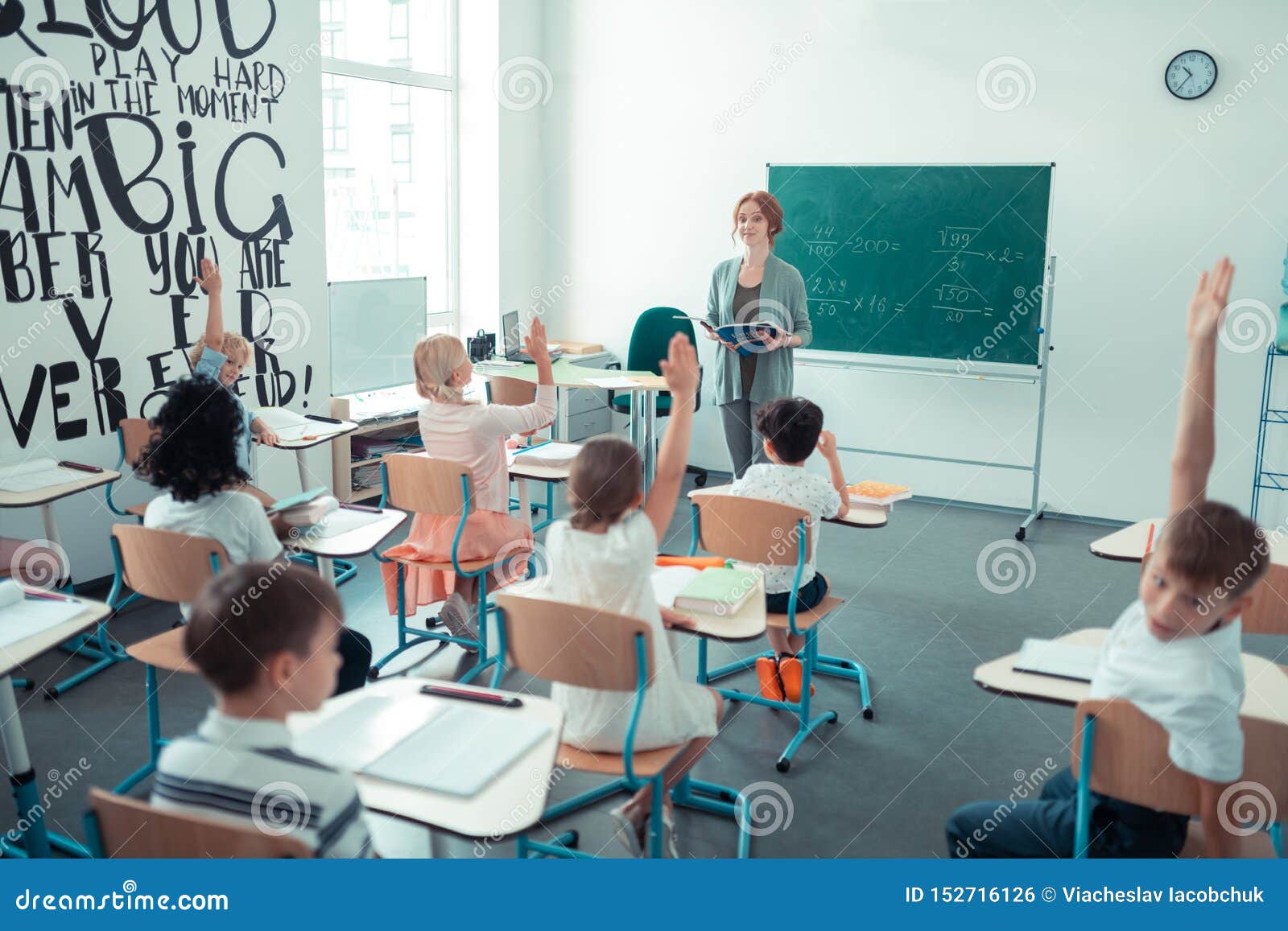 Maths Teacher Reading a Mathematical Problem in the Classroom. Stock ...