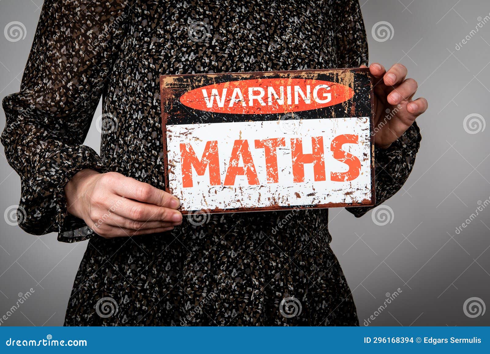 MATHS. Warning Sign with Text in the Hands of a Woman Stock Photo ...