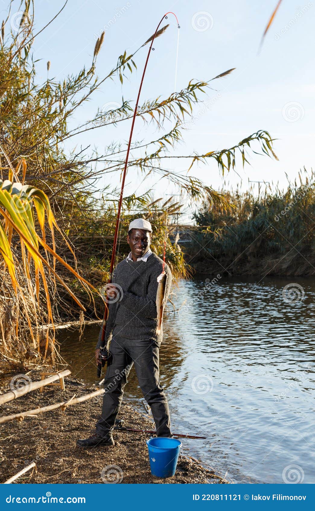 Man pulling fish on hook stock image. Image of person - 220811121