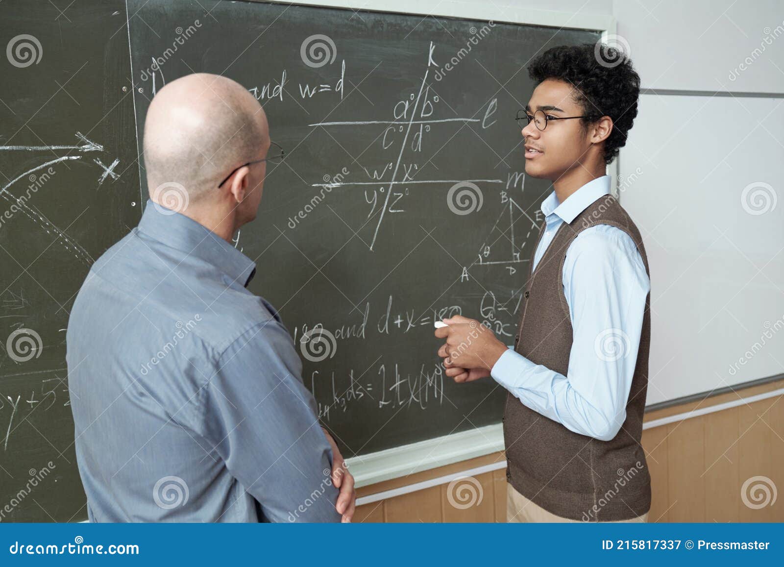 Mature Bald Professor and Young Mixed-race Student Discussing Solution ...
