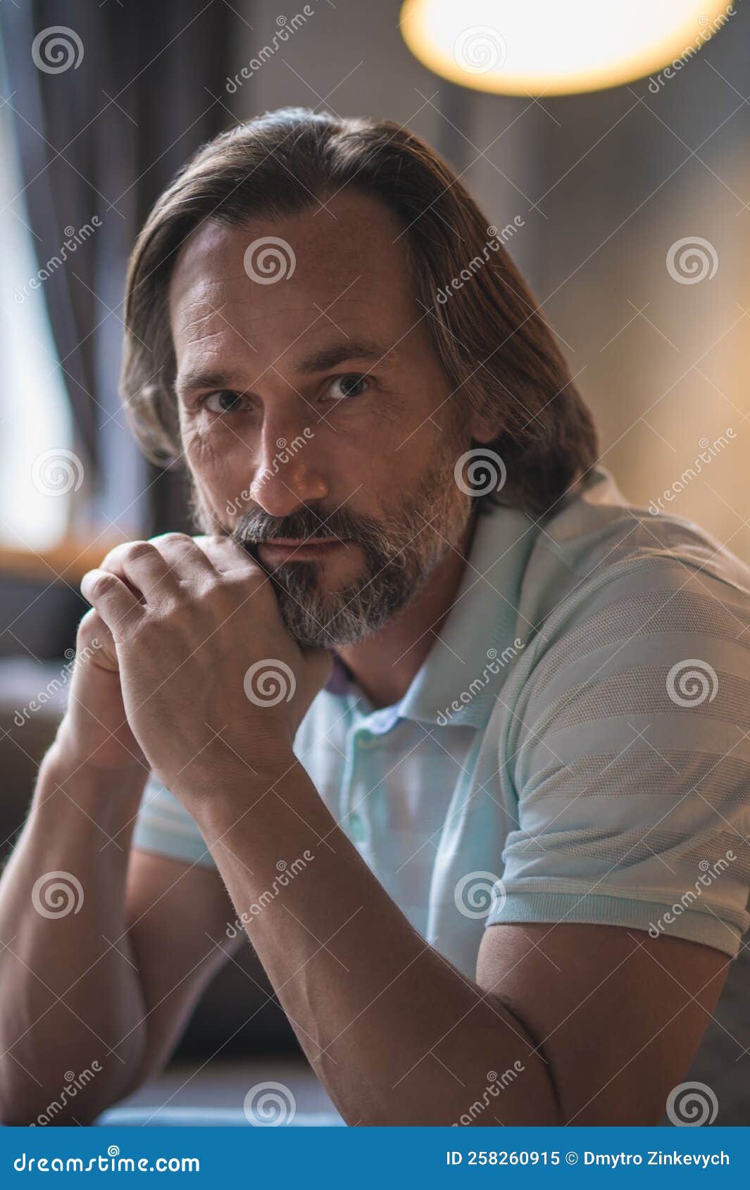 Mature Bearded Man Sitting With A Thoughtful Look Stock Image Image