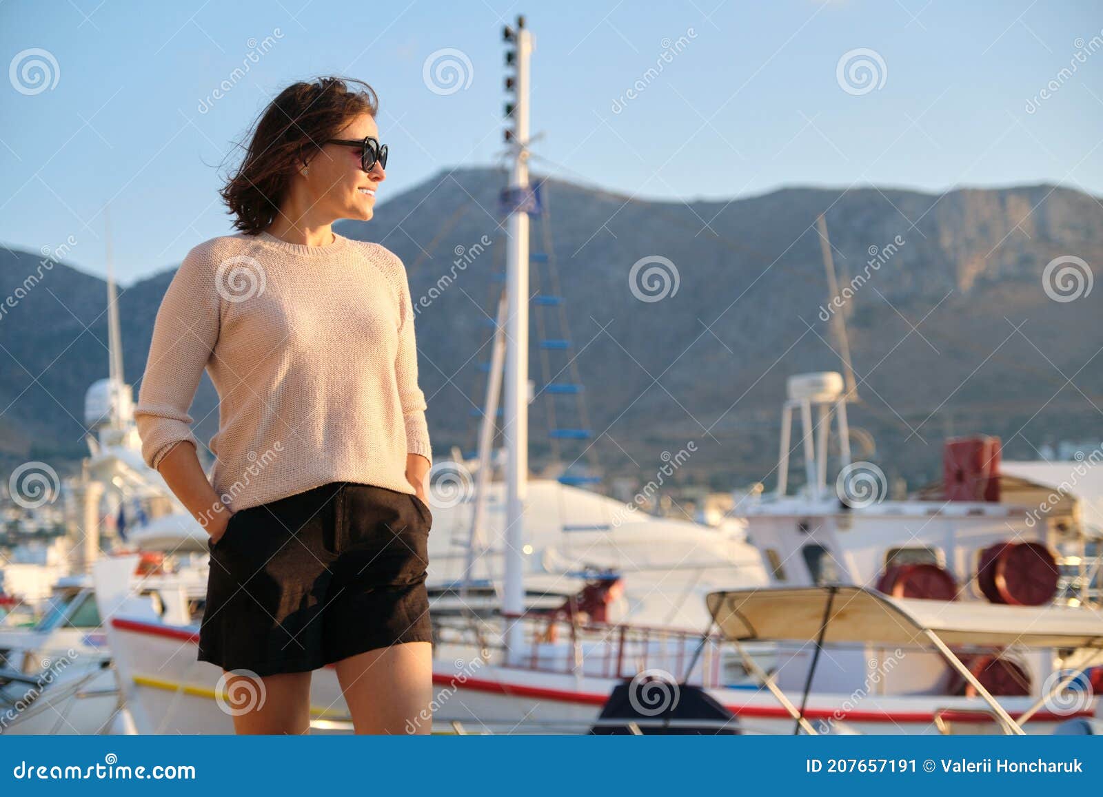 Mature Beautiful Happy Woman In Sunglasses Walking Along The Sea Pier