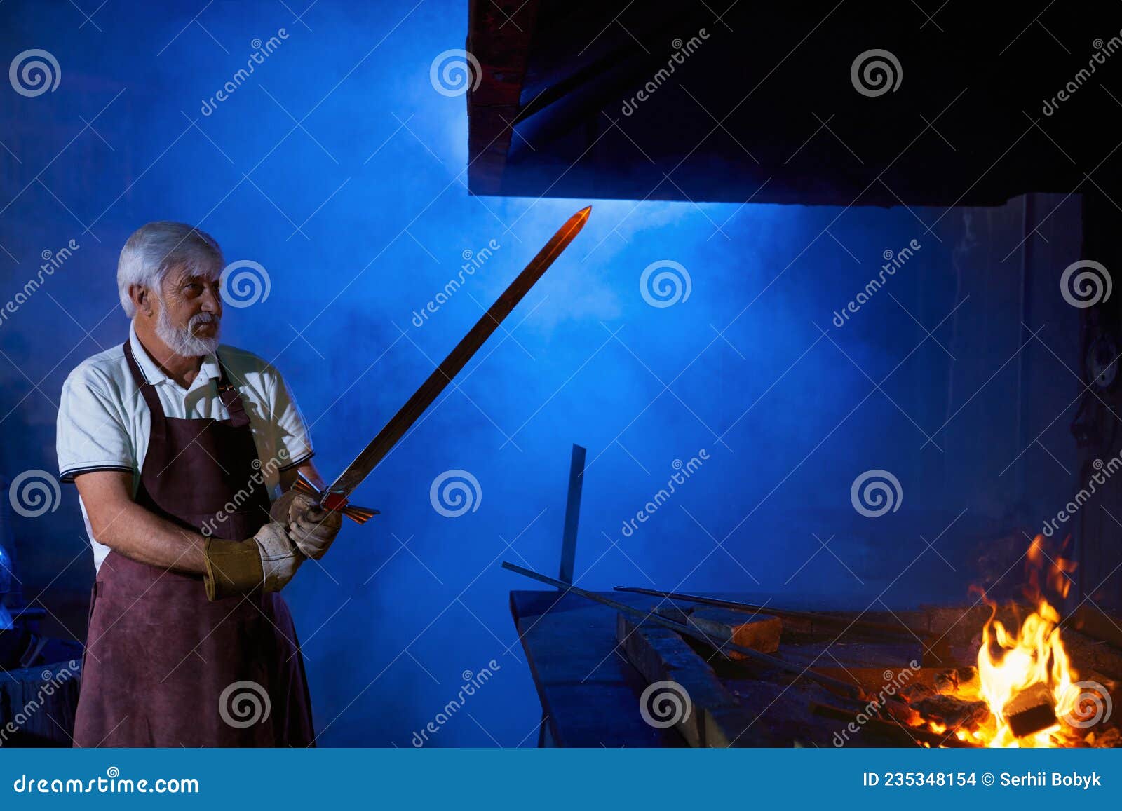 Mature Blacksmith in Gloves Making Sword at Workplace Stock Photo ...