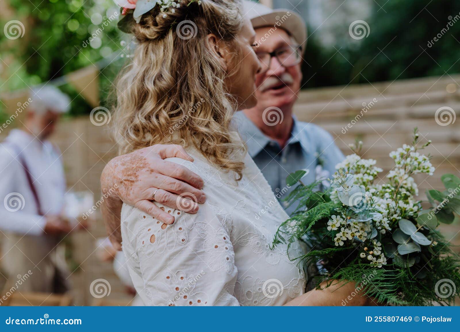 Mature Bride Receiving Congratulations at Wedding Reception Outside in ...