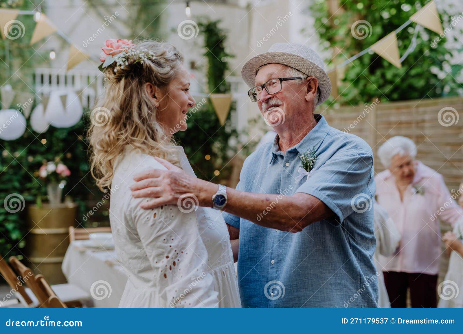 Mature Bride Receiving Congratulations at Wedding Reception Outside in ...