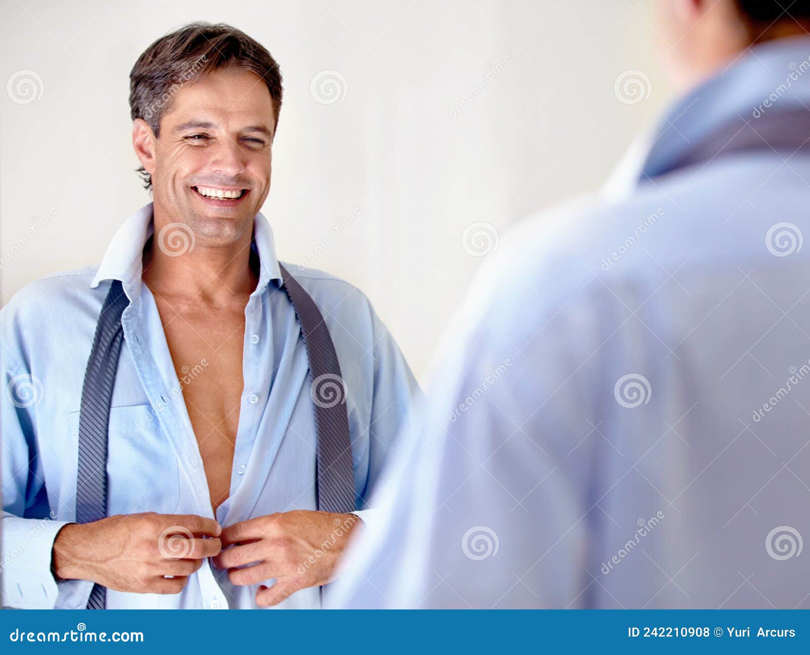 Getting Ready for Work in Front of the Mirror. a Mature Businessman ...