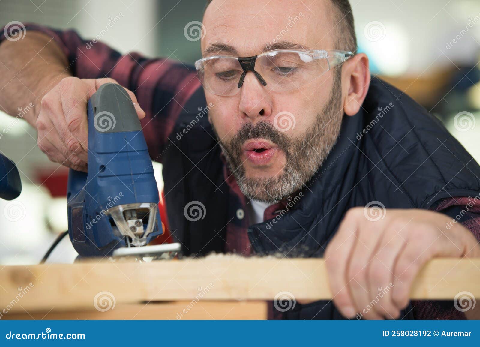Mature Carpenter Blowing Dust while Using Jigsaw Stock Photo - Image of ...