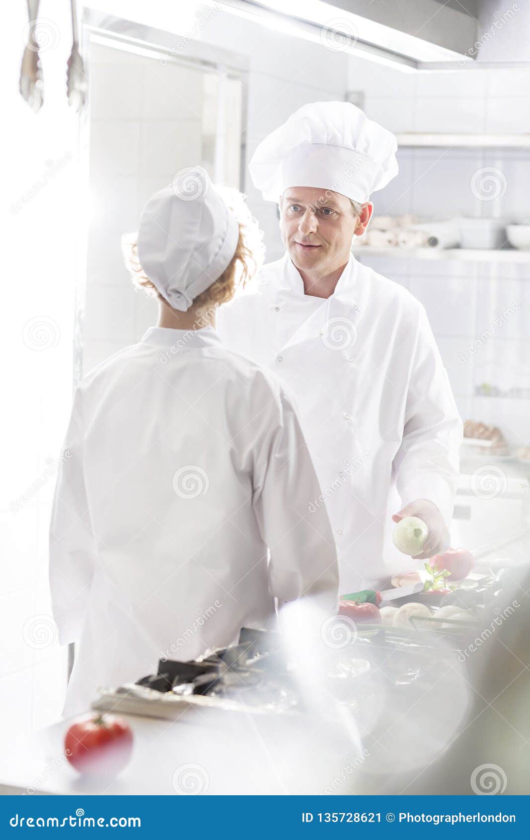 Mature Chefs Talking while Standing in Kitchen at Restaurant Stock ...