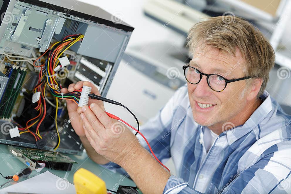 Mature Computer Engineer Examining Computer Stock Photo - Image of ...
