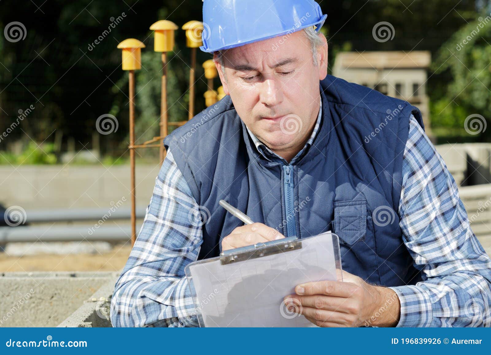 Mature Construction Manager Writing Report at Construction Site Stock ...