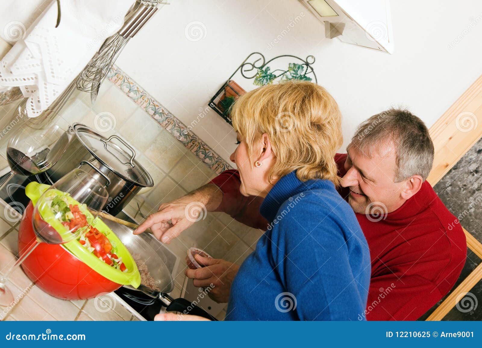 Mature Couple Cooking Dishes in Kitchen Stock Image - Image of adult ...