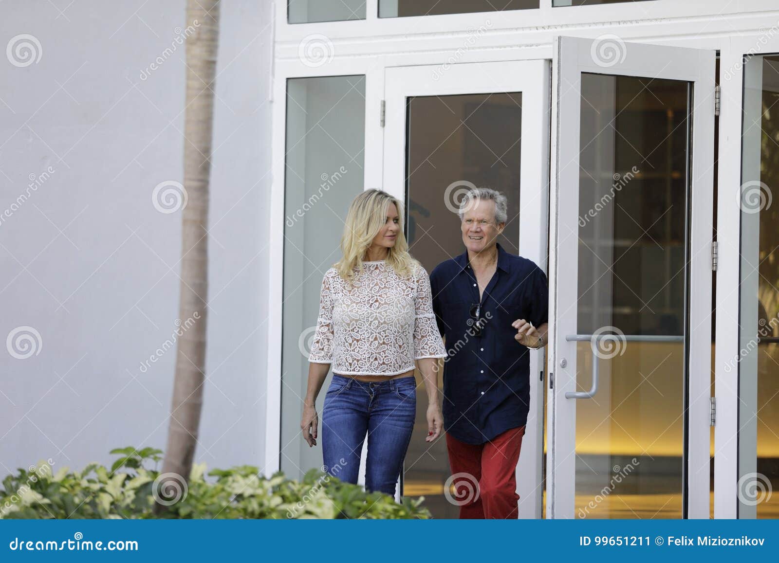 Mature Couple Exiting a Building Stock Image - Image of building, hair ...
