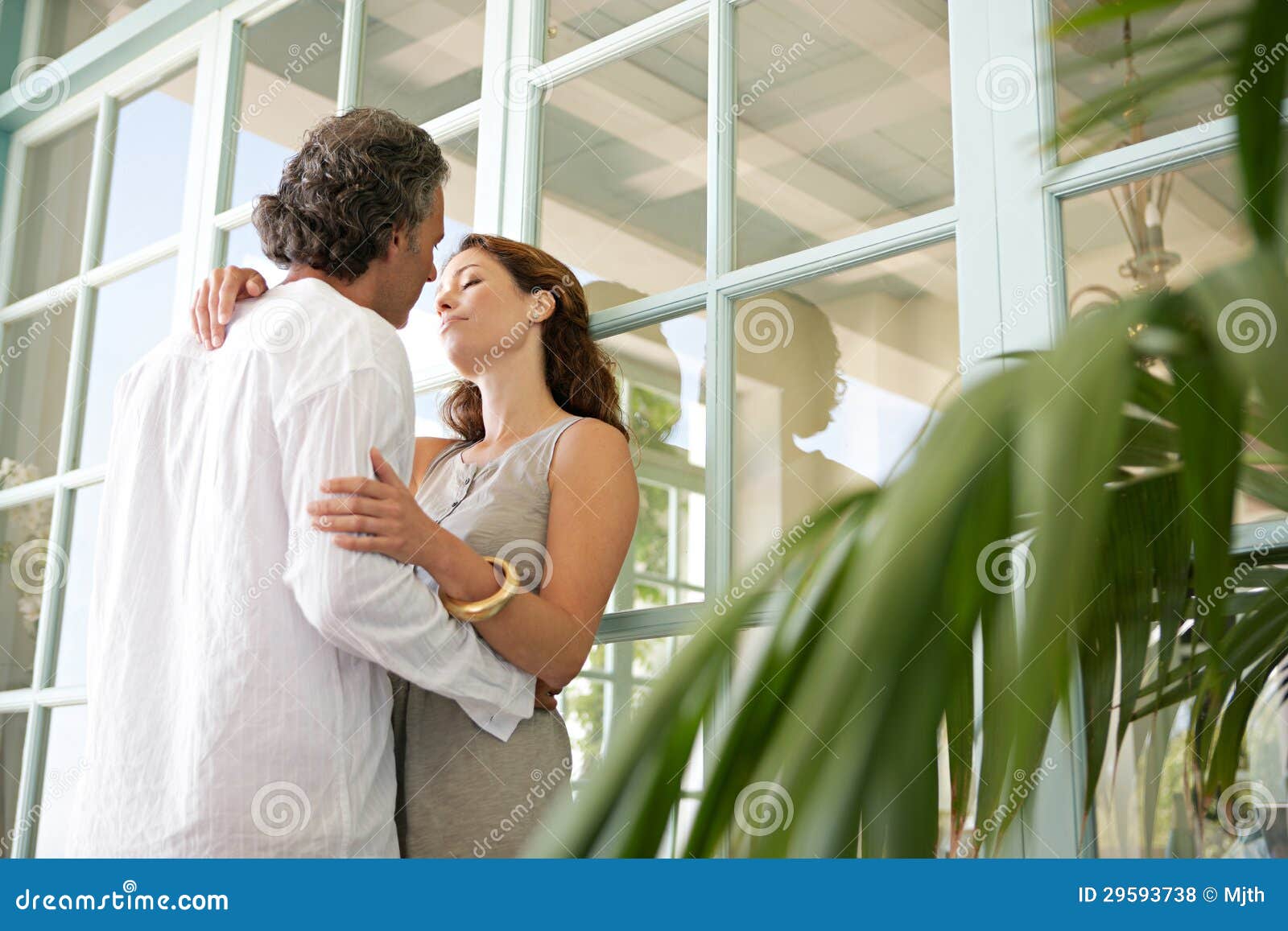 Mature Couple Hugging at Home. Stock Photo - Image of glass, garden ...