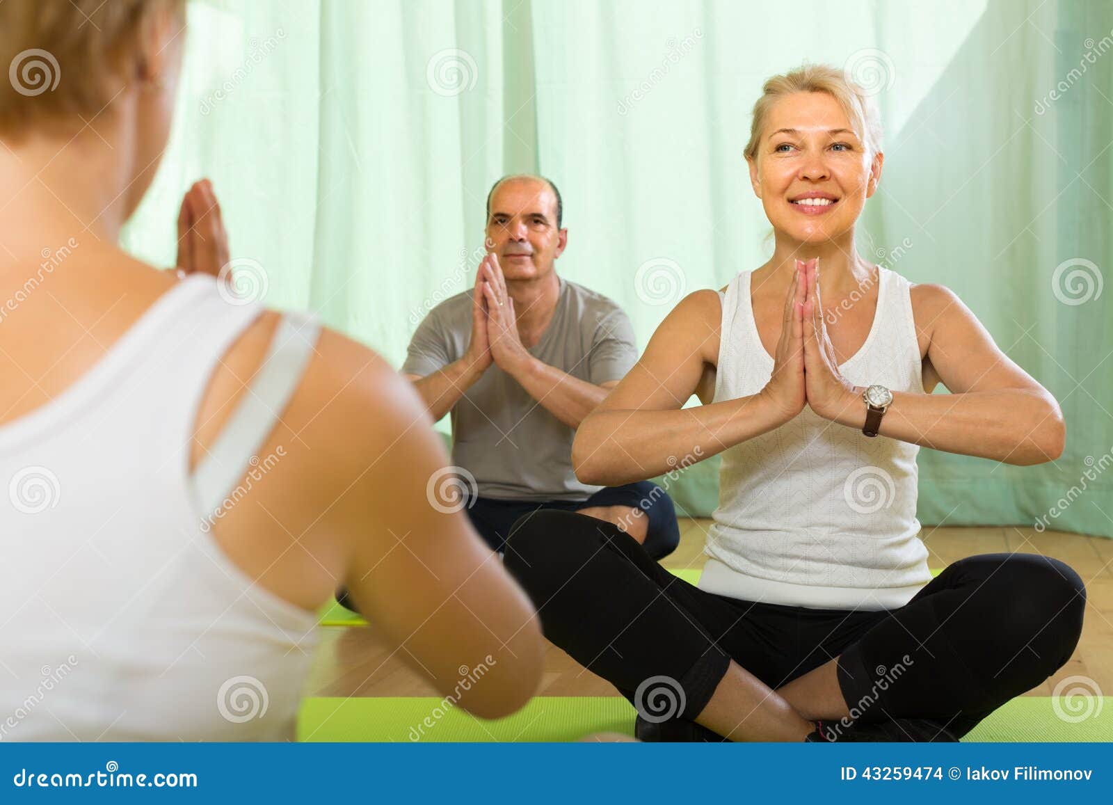 Mature Couple Practicing Yoga with Instructor Stock Photo - Image of ...