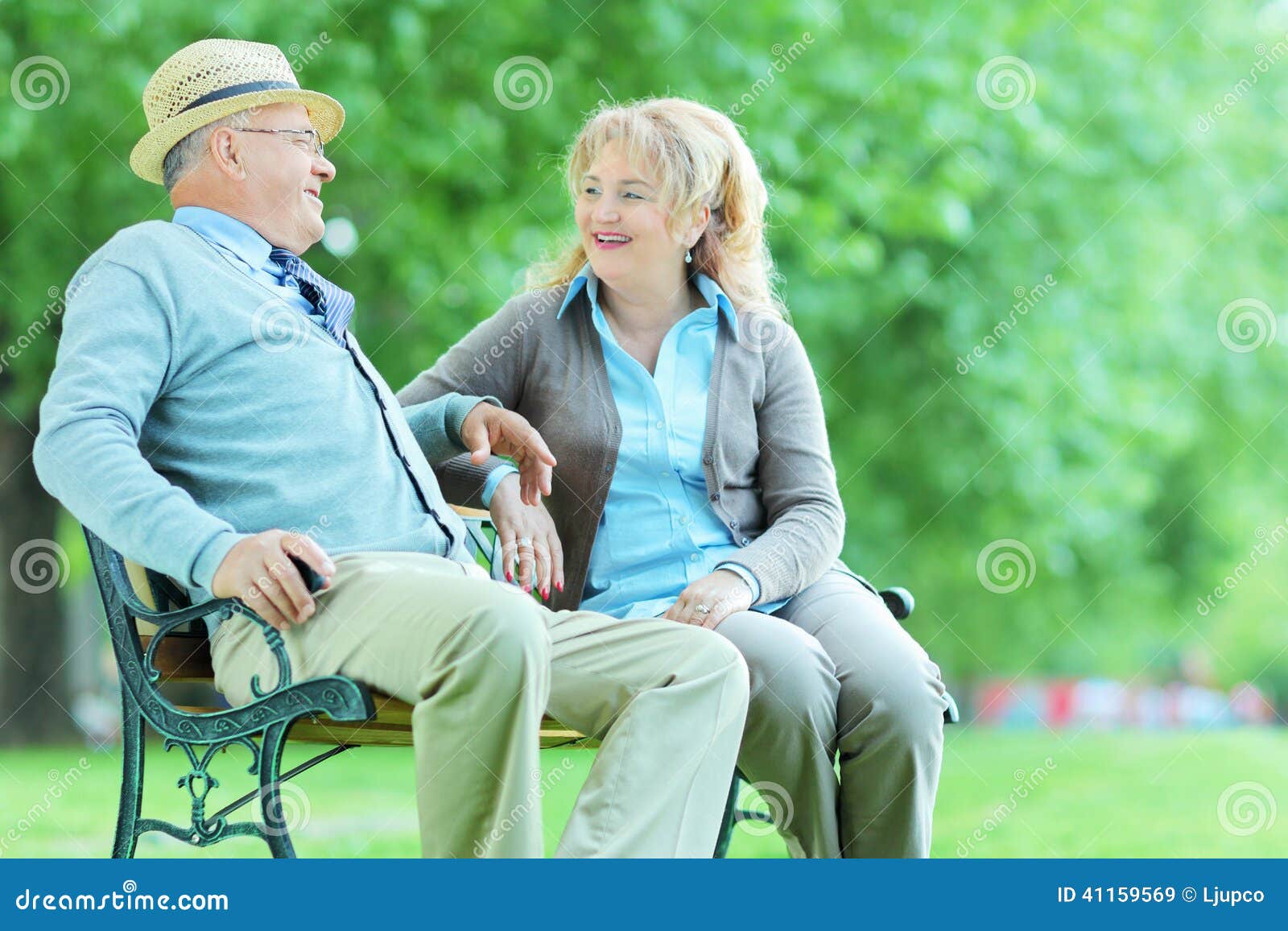 Mature Couple Talking Seated in Park Stock Image - Image of caucasian ...
