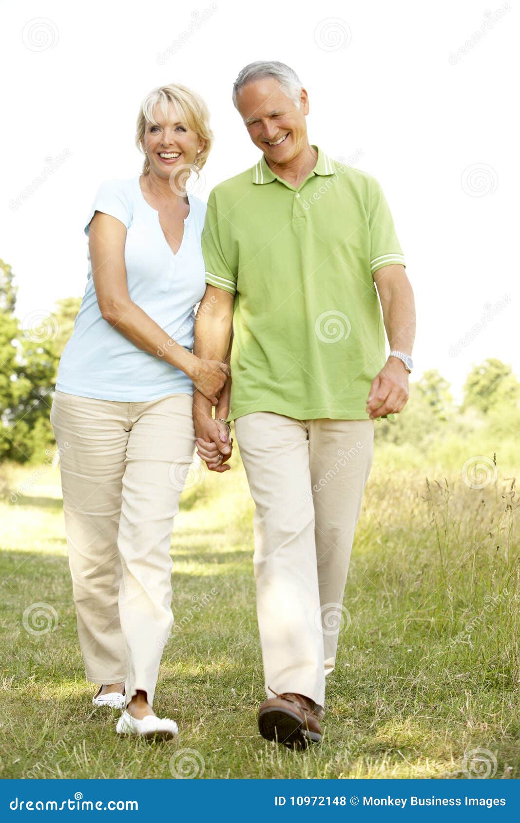 Mature Couple Walking in Countryside Stock Photo - Image of laughing ...
