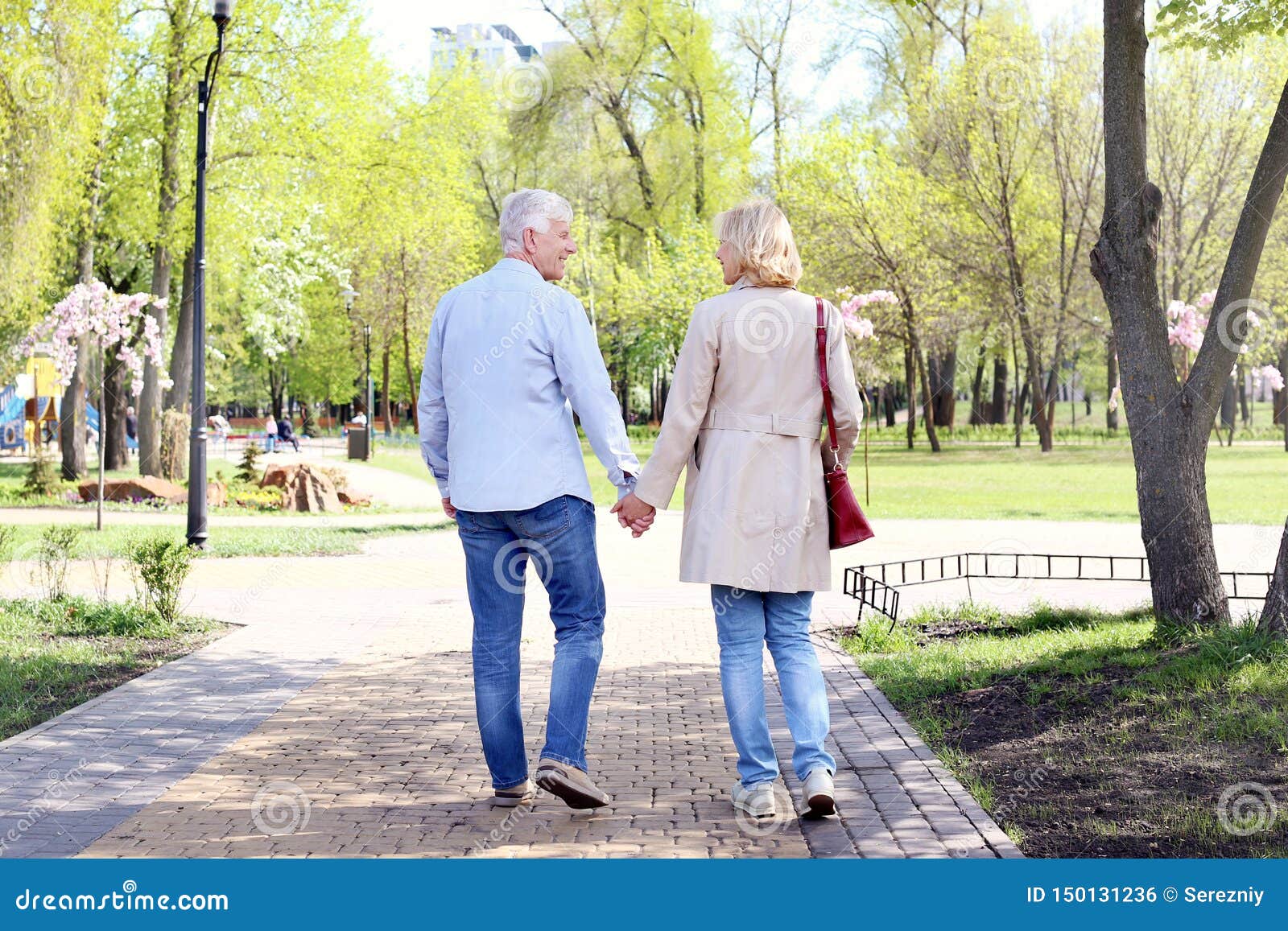 Mature Couple Walking in Park on Spring Day Stock Photo - Image of ...
