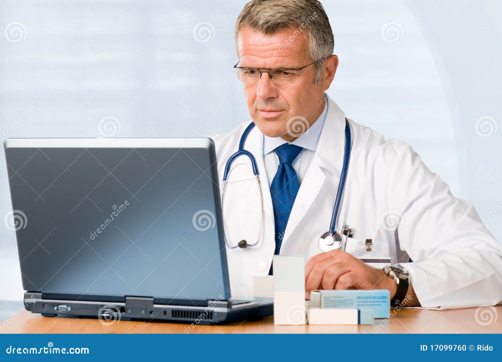 Mature Doctor Working on Laptop Stock Photo - Image of adult, health ...