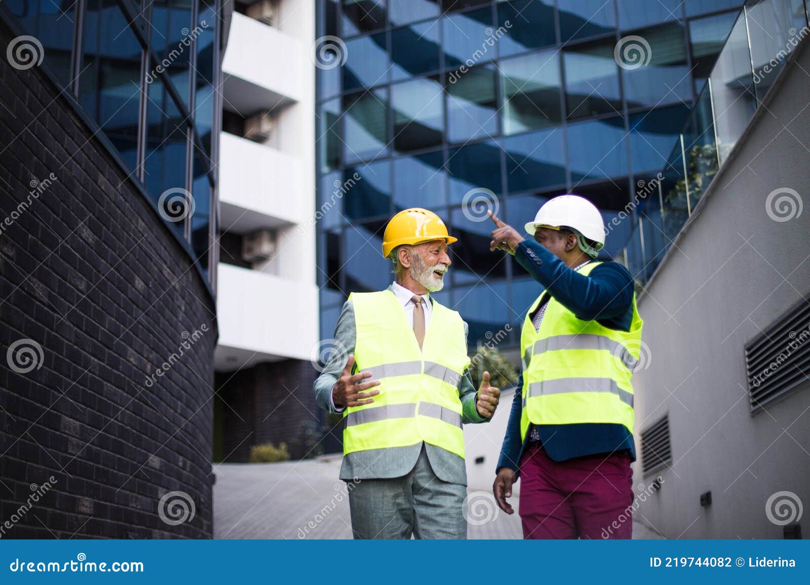 Engineer Discussing the Structure of the Building with Architects ...