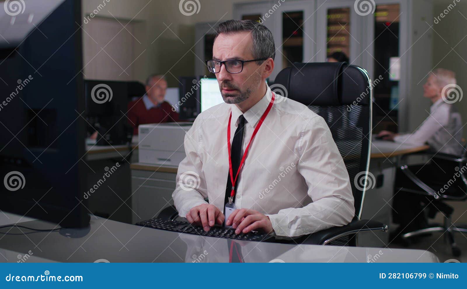 Mature Engineer Sit Down at Desk and Work on Computer in Industrial ...