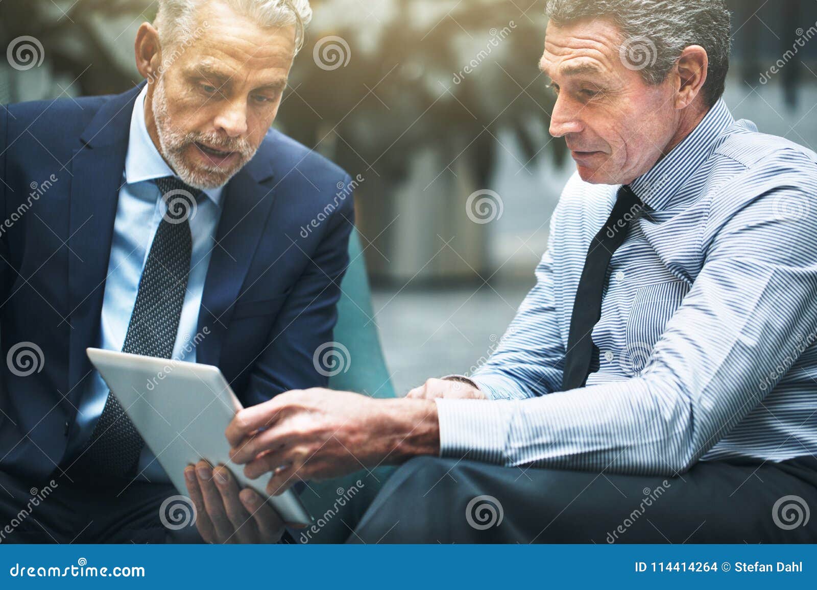 Mature Executives Using a Tablet Together in an Office Stock Photo ...