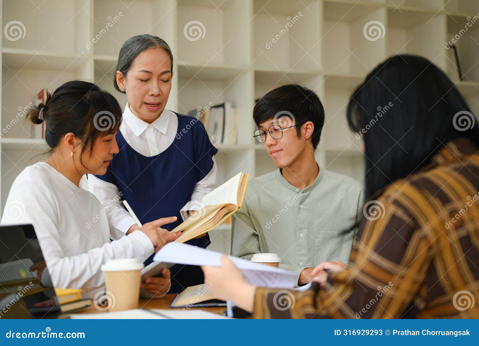 Mature Female Lecturer Helping Student during Her Class. Education ...