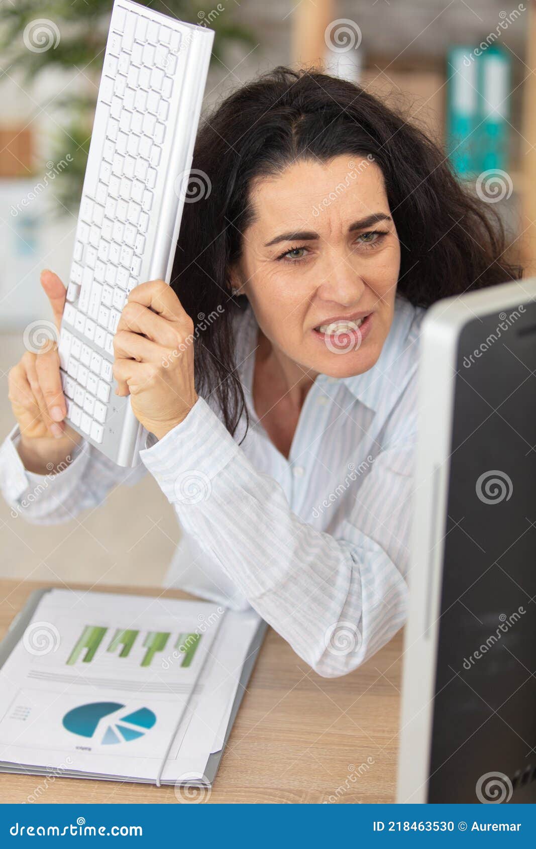 Mature Female Office Worker Threatens To Hit Computer with Keyboard ...