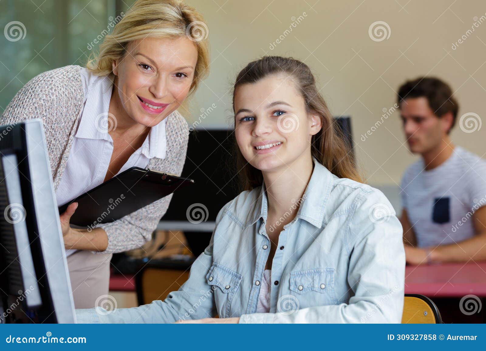 Mature Female Teacher Guiding Student Using Computer Stock Photo ...