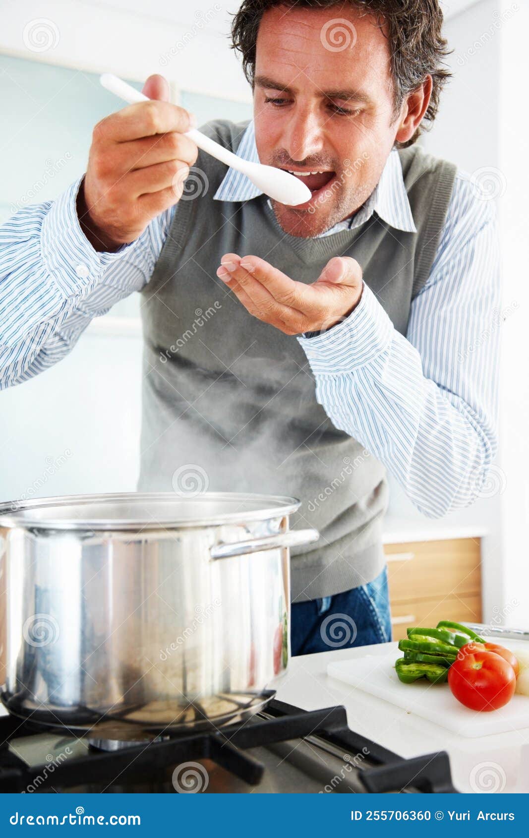 Mature Guy Tasting Food he is Preparing. Portrait of a Mature Guy ...