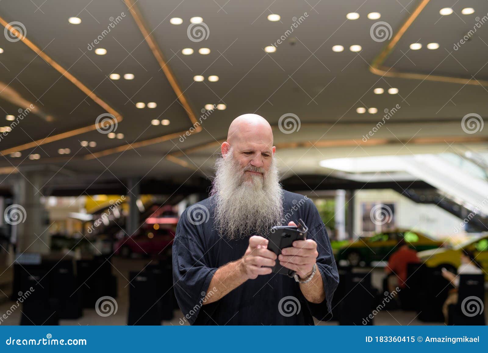 Mature Handsome Bald Bearded Man Using Phone in the City Outdoors Stock ... Mature Handsome Bald Bearded Man Using Phone in the City Outdoors Stock ...