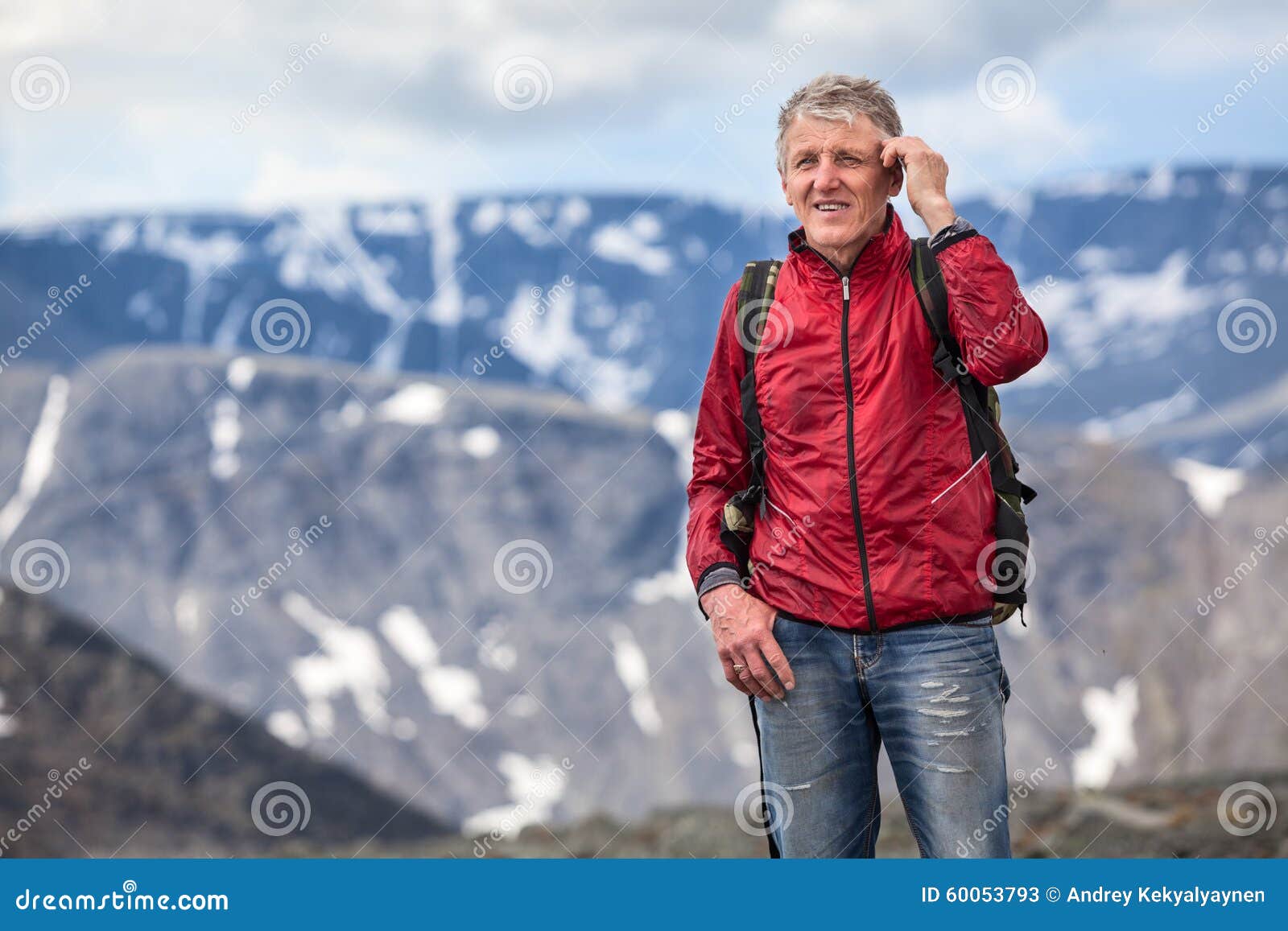 Mature Hiker Talking on Mobile Phone and Looking at Camera on High of ...