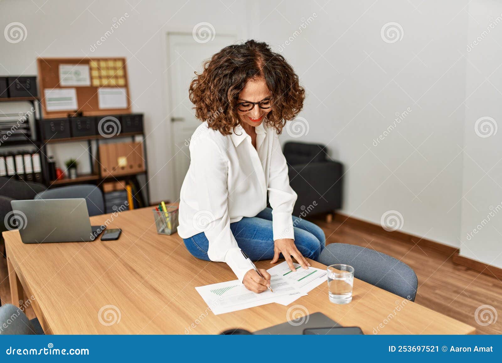 Mature Hispanic Woman Working Looking at Papers at the Office Stock ...