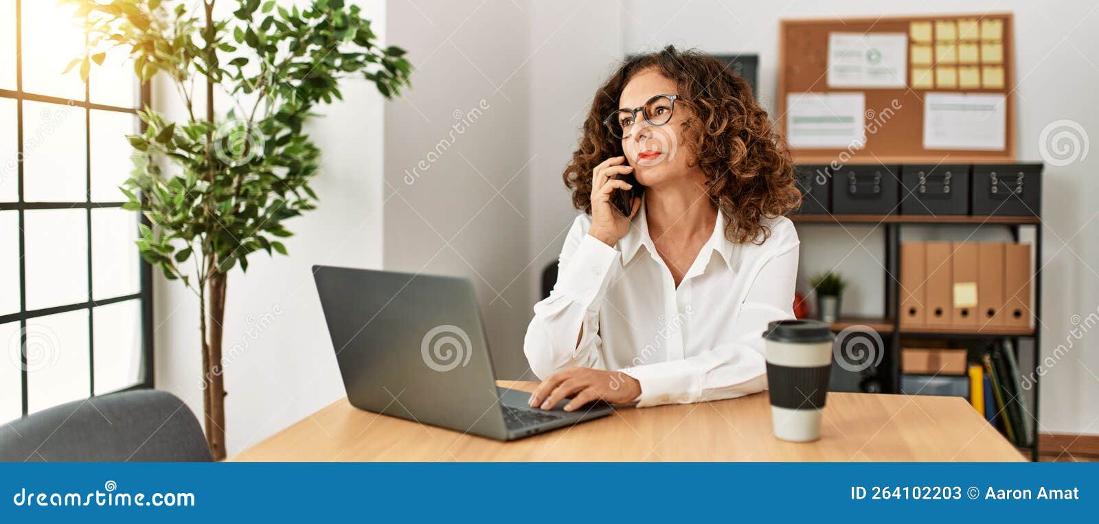 Mature Hispanic Woman Working Speaking on the Phone at the Office Stock ...