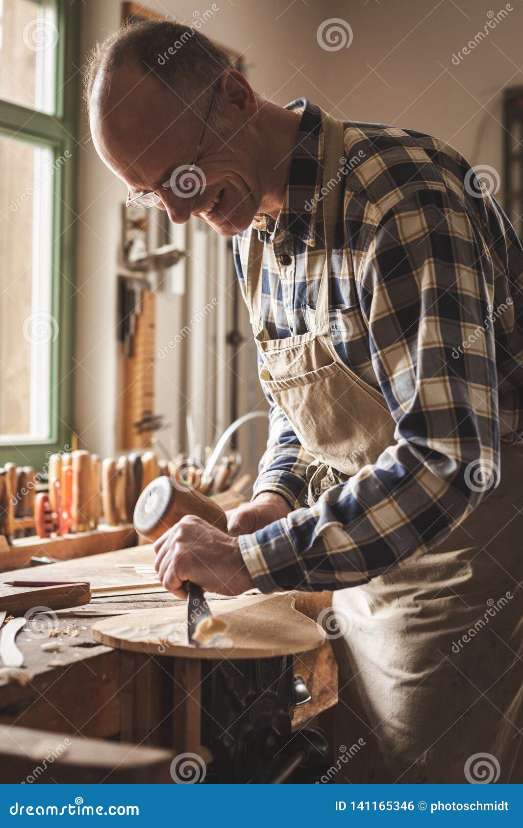 Mature Instrument Maker Inside A Rustic Workshop Is Winding A Wire ...