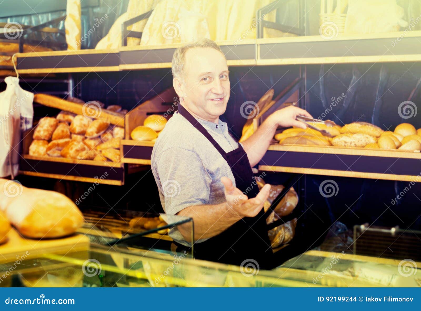 Mature Man Baker Offering Fresh Baguettes and Buns Stock Photo - Image ...